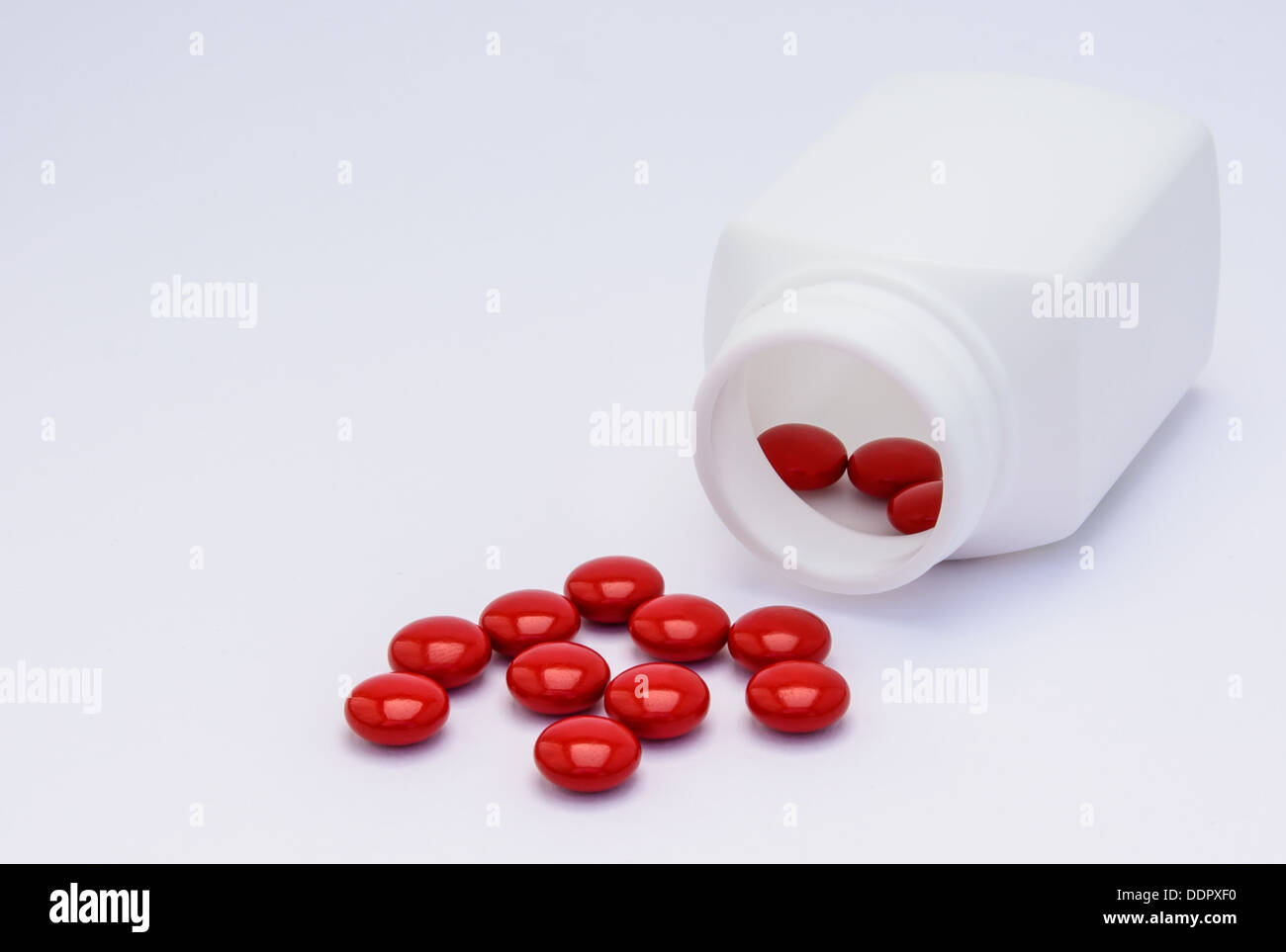 isolated red pill in the bottle and out Stock Photo - Alamy