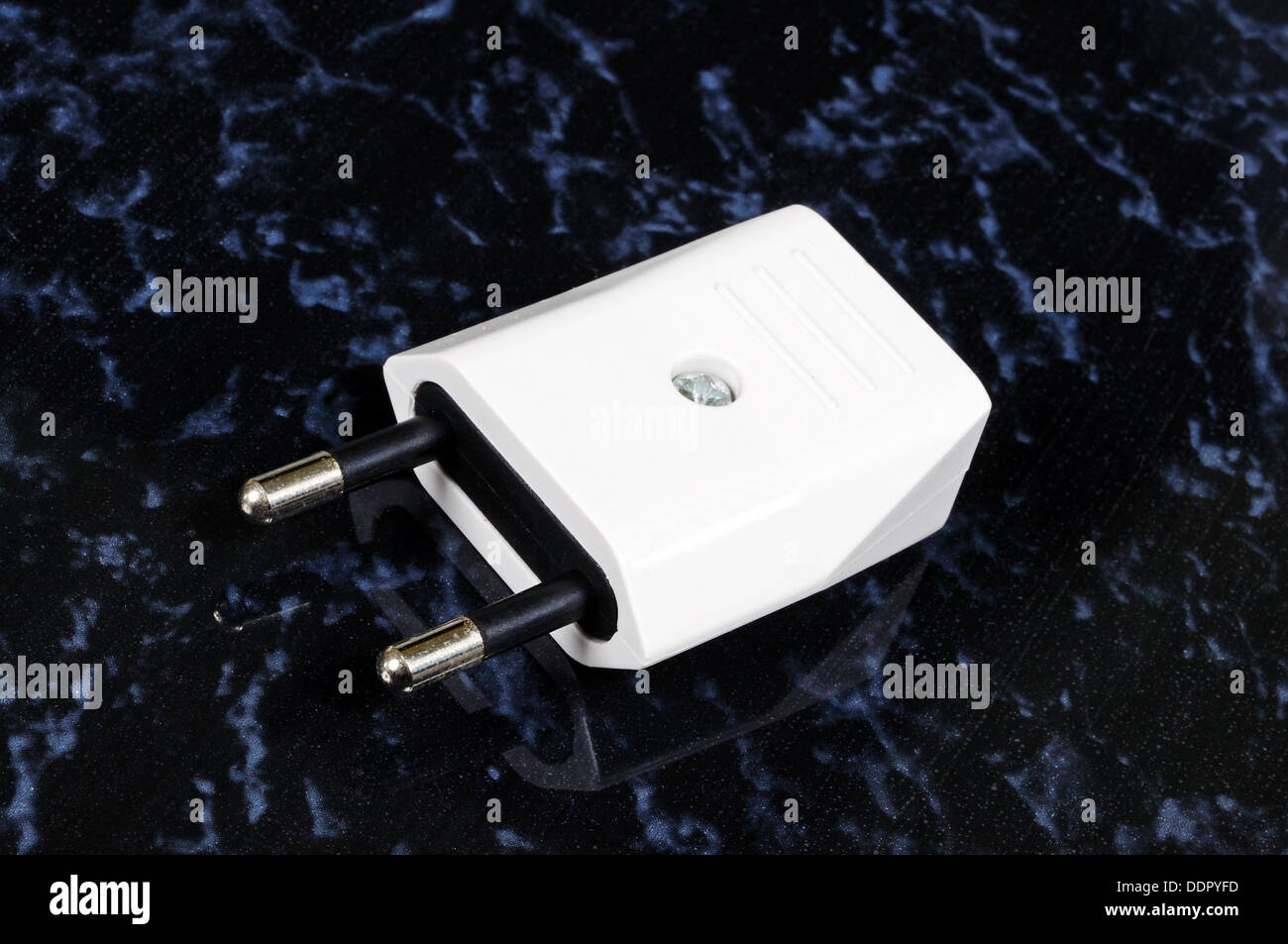European style two pin mains plug (CEE 7/16 Europlug) against a dark ...