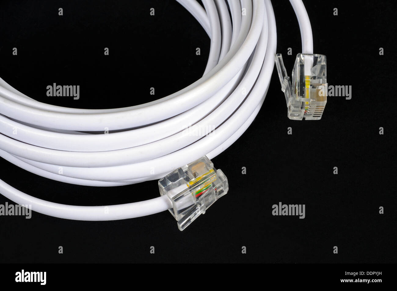 Telephone connector against a black background Stock Photo - Alamy