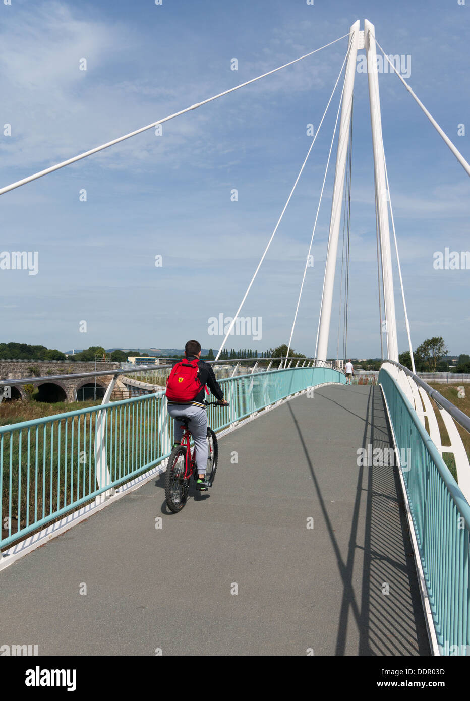Cyclist crossing the new Town Quay Bridge over the river Teign in ...