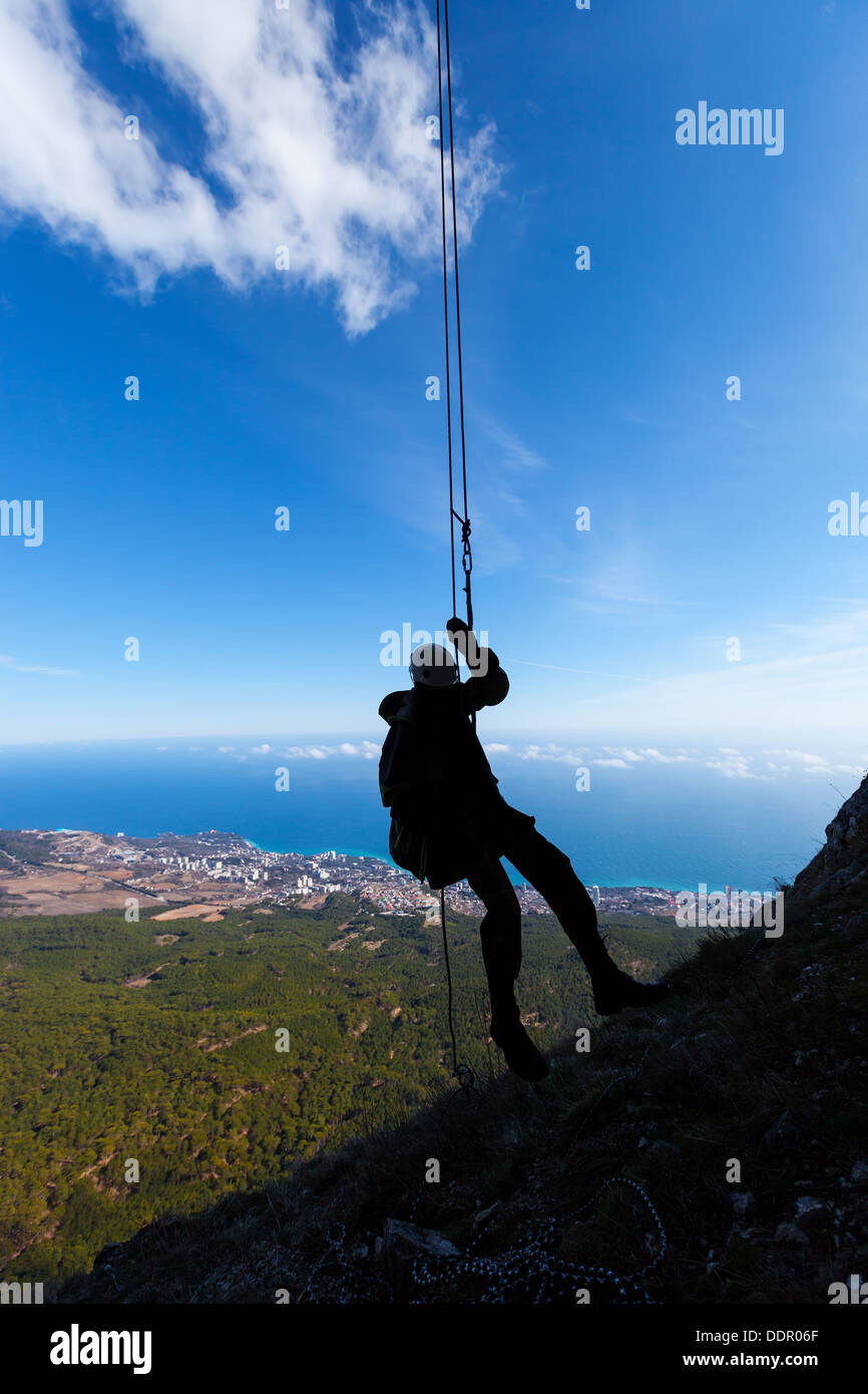 Silhouette of a rappelling man Stock Photo - Alamy