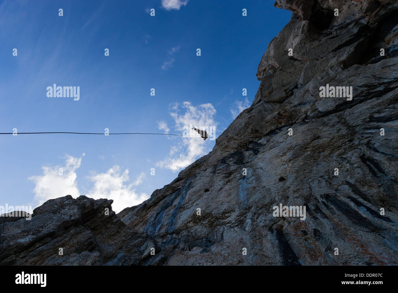 Silhouette of a rappelling man Stock Photo - Alamy