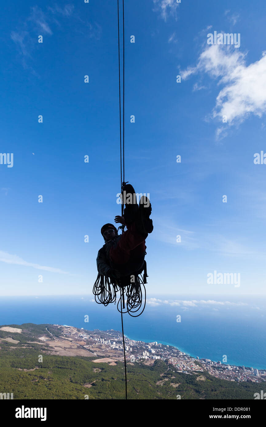 Silhouette of a rappelling man Stock Photo - Alamy