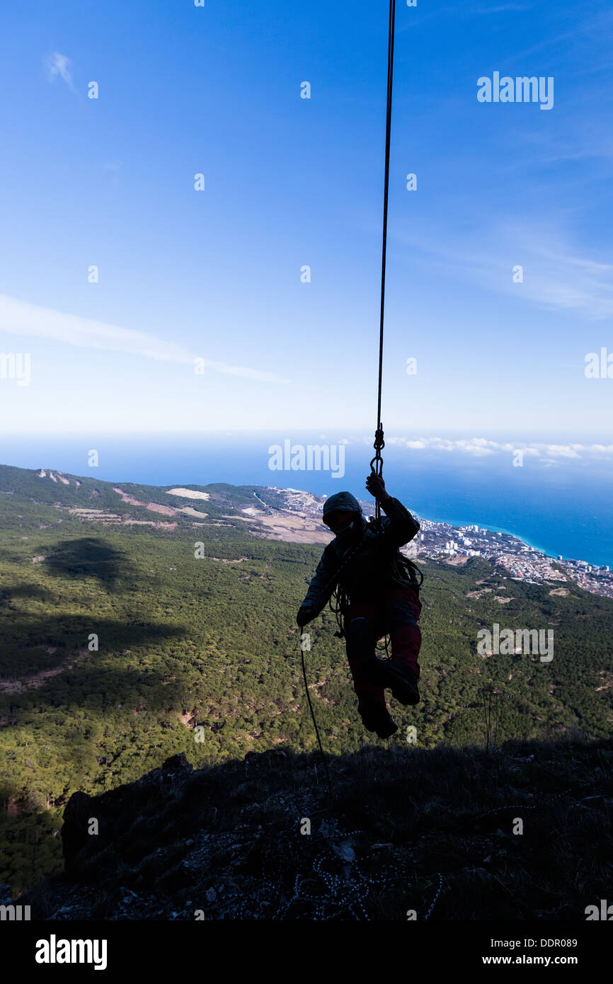 Silhouette of a rappelling man Stock Photo - Alamy