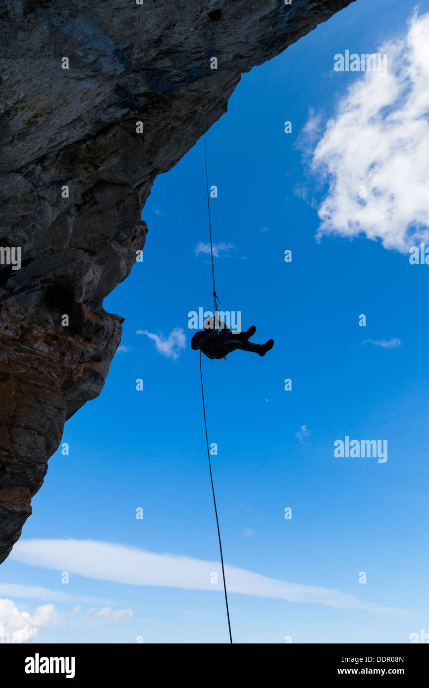 Silhouette of a rappelling man Stock Photo - Alamy