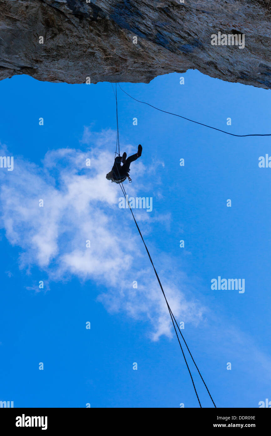 Silhouette of a rappelling man Stock Photo - Alamy