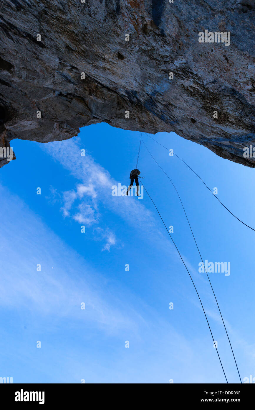 Silhouette of a rappelling man Stock Photo - Alamy