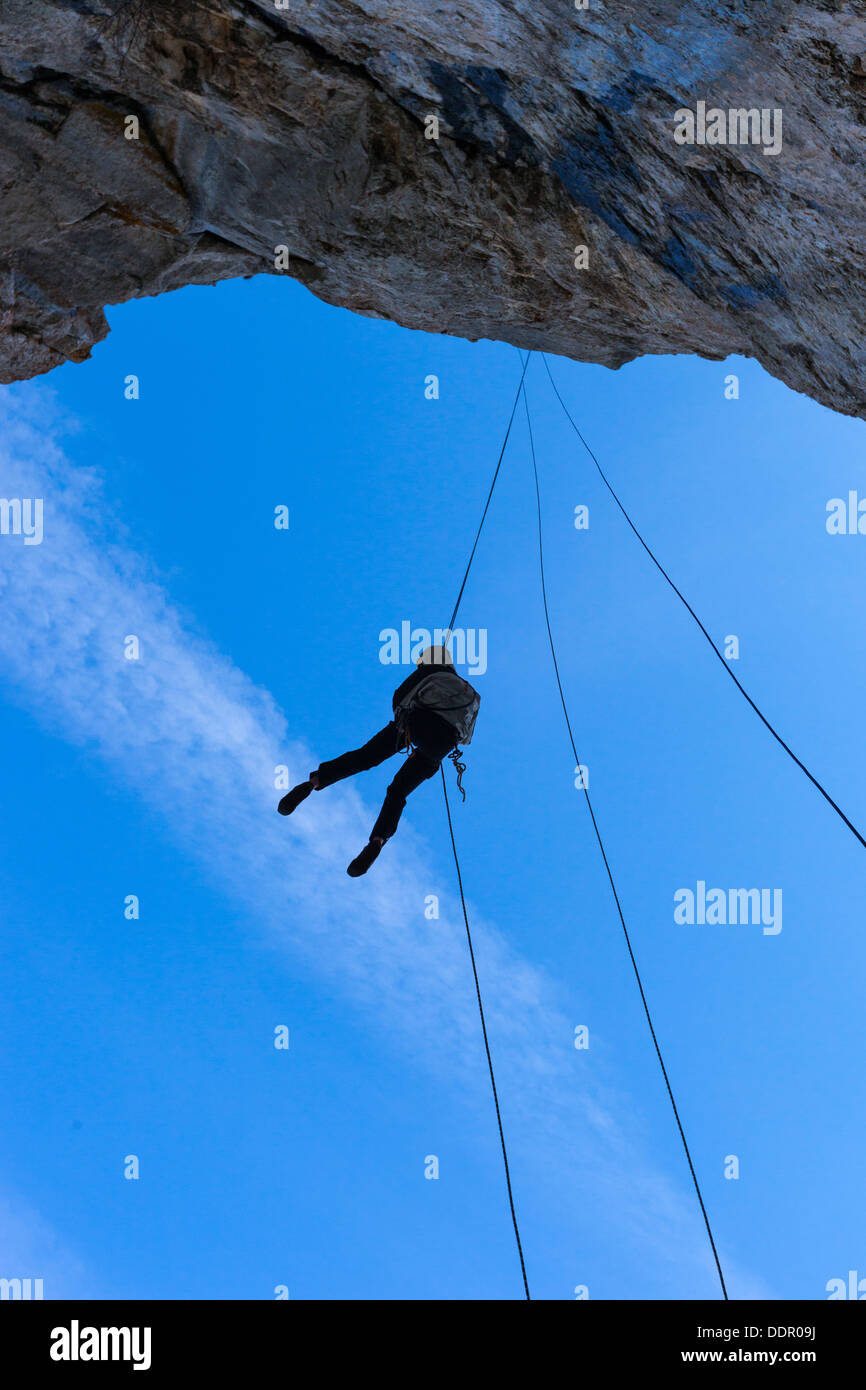 Silhouette of a rappelling man Stock Photo - Alamy