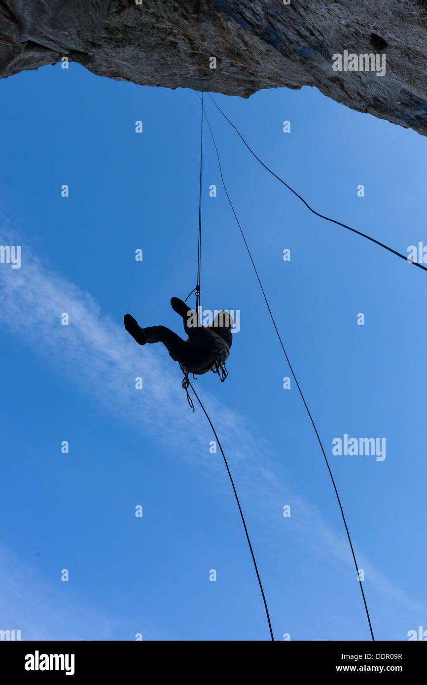 Silhouette of a rappelling man Stock Photo - Alamy