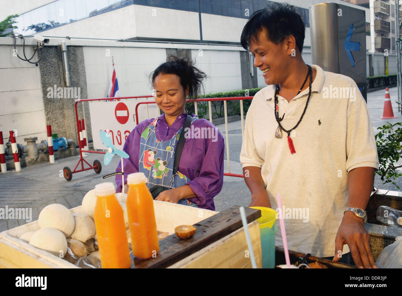 Couple at a street side stall at Ploenchit Road in downtown Bangkok ...
