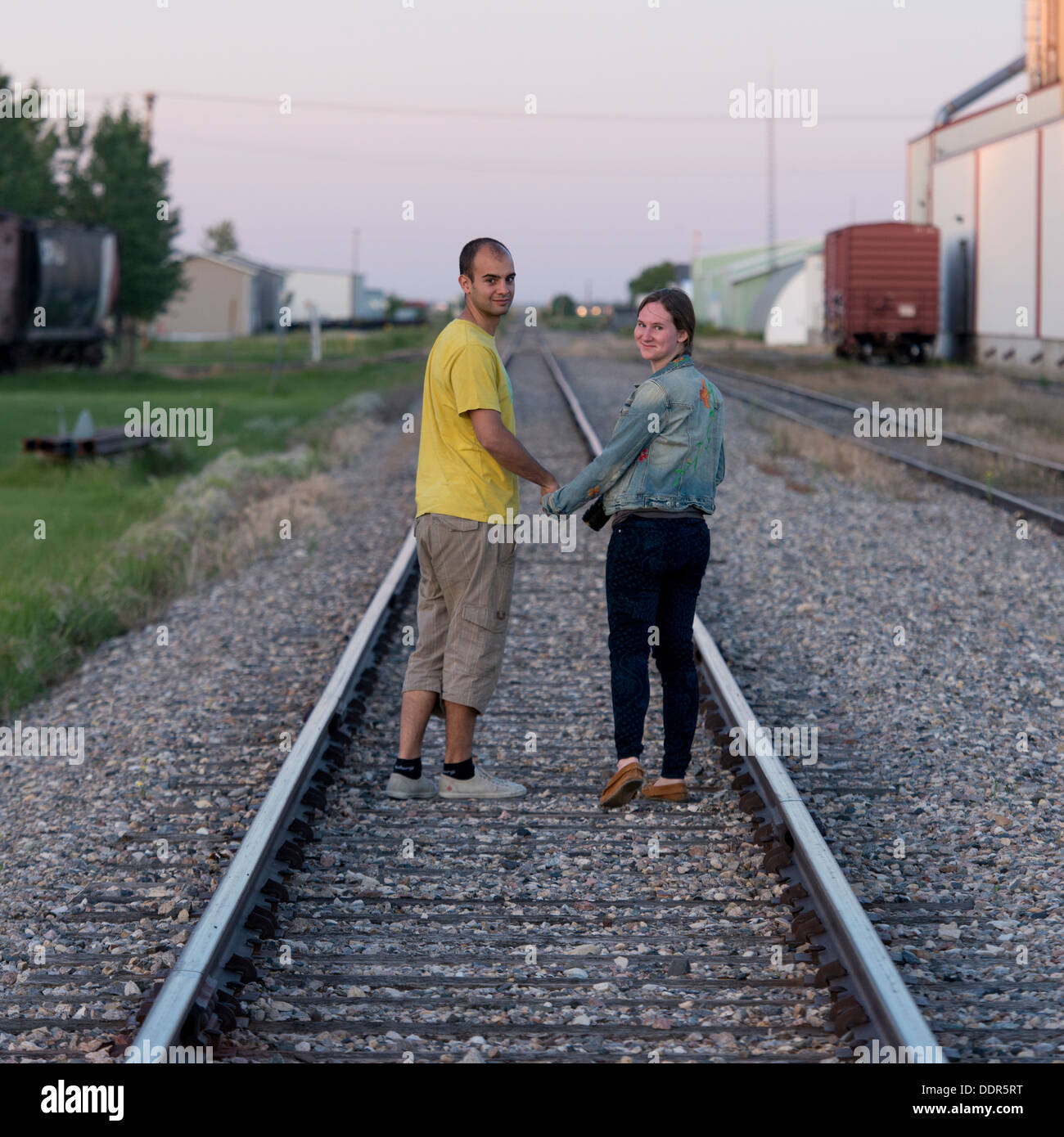 Couple standing between railroad tracks hi-res stock photography and ...