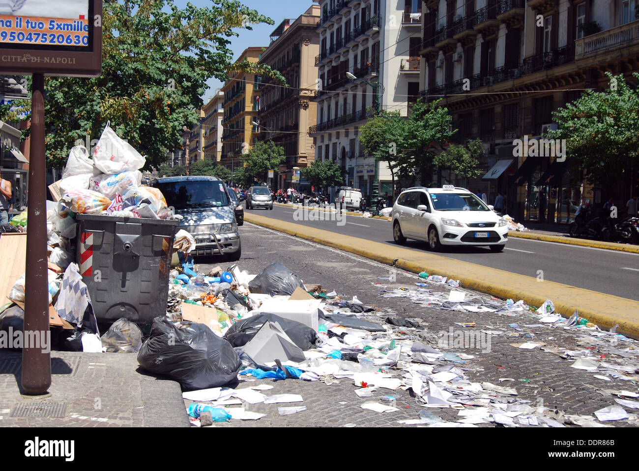 Garbage in the streets of Naples with passing car Stock Photo - Alamy