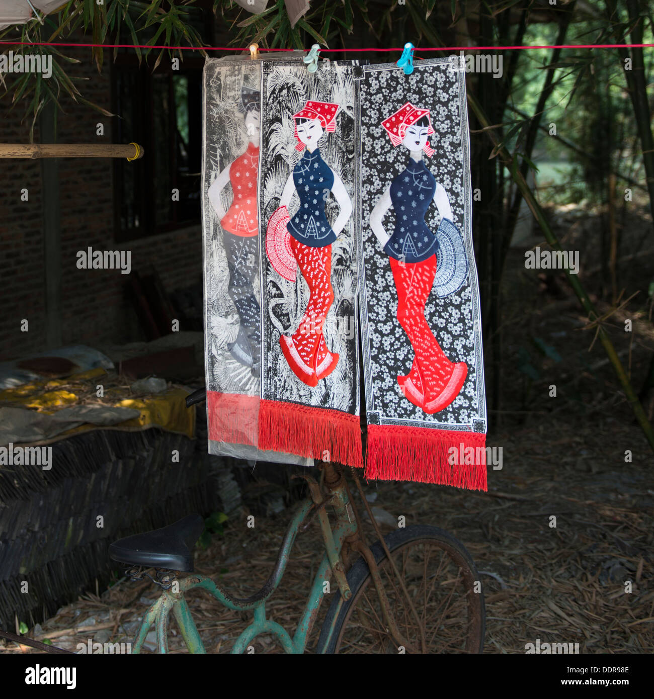 Display of traditional paintings hanging by clothespin, Xingping ...