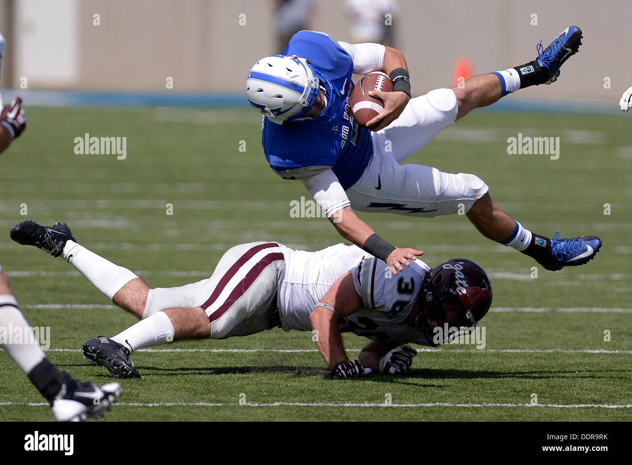 Quarterback Kale Pearson, a junior, is tackled by Colgates Kris Kent as ...