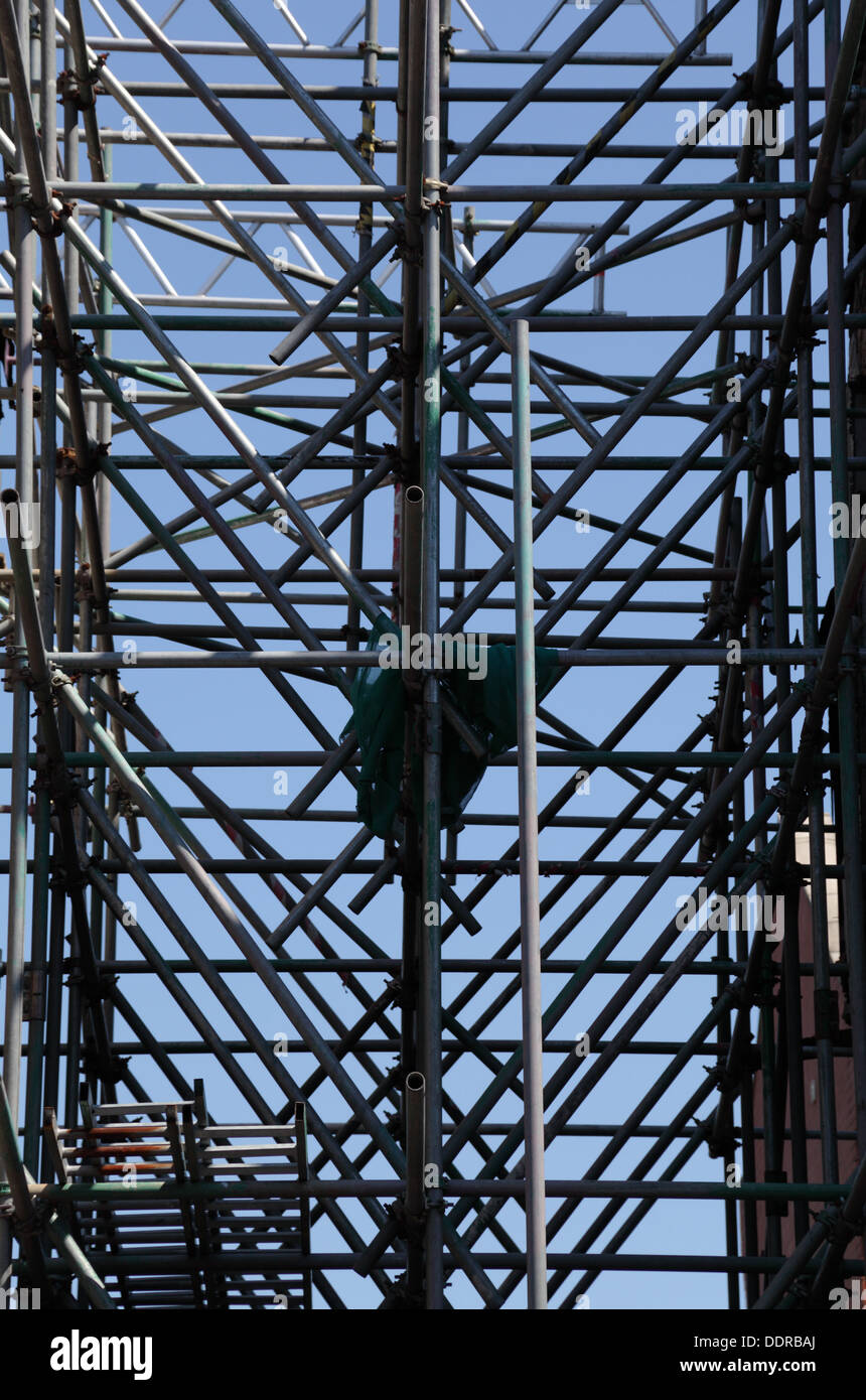 Scaffolding against the sky between riot damaged shops in Peckham south ...