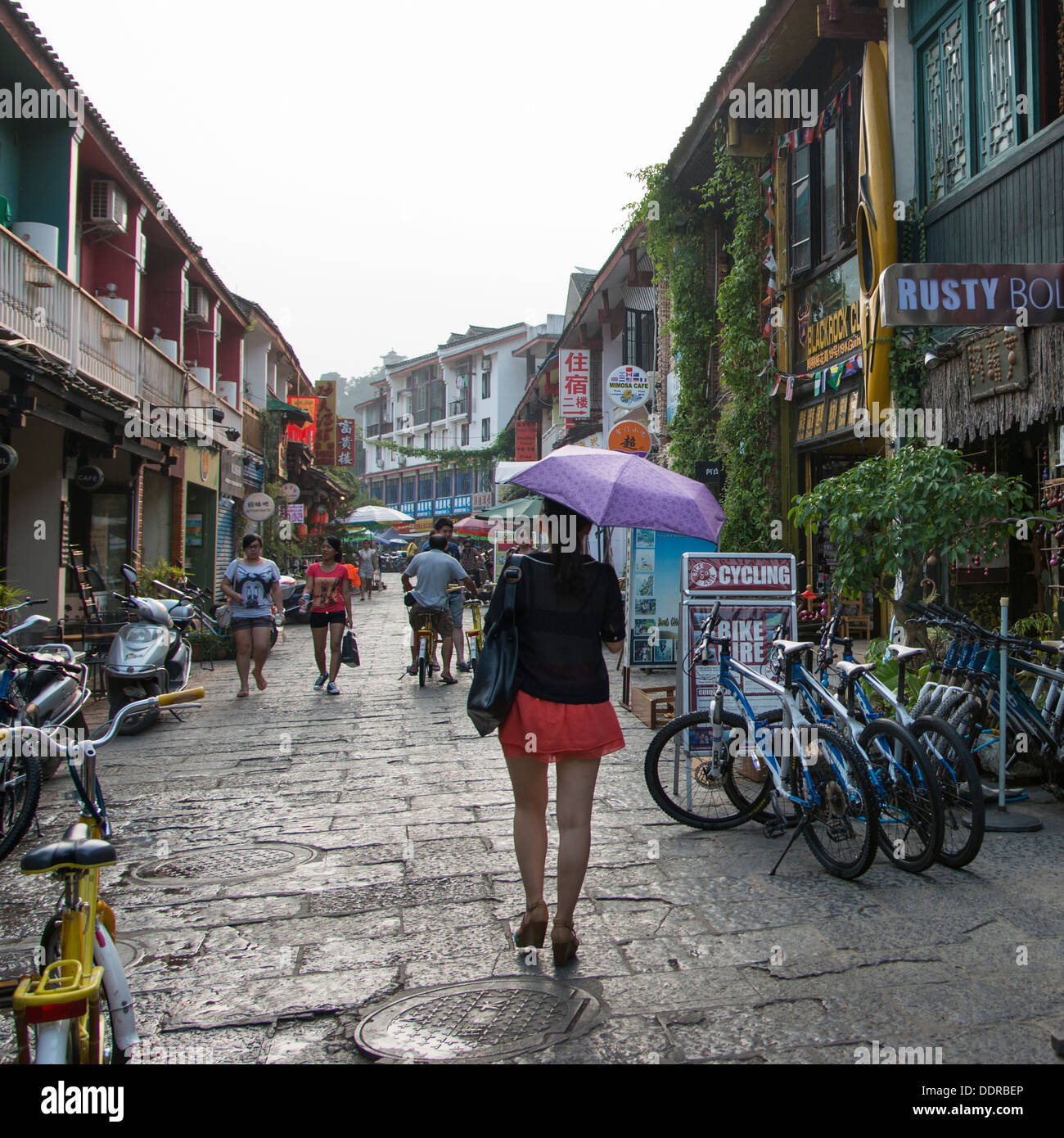 Tourists on a street, West Street, Yangshuo, Guilin, Guangxi Province ...