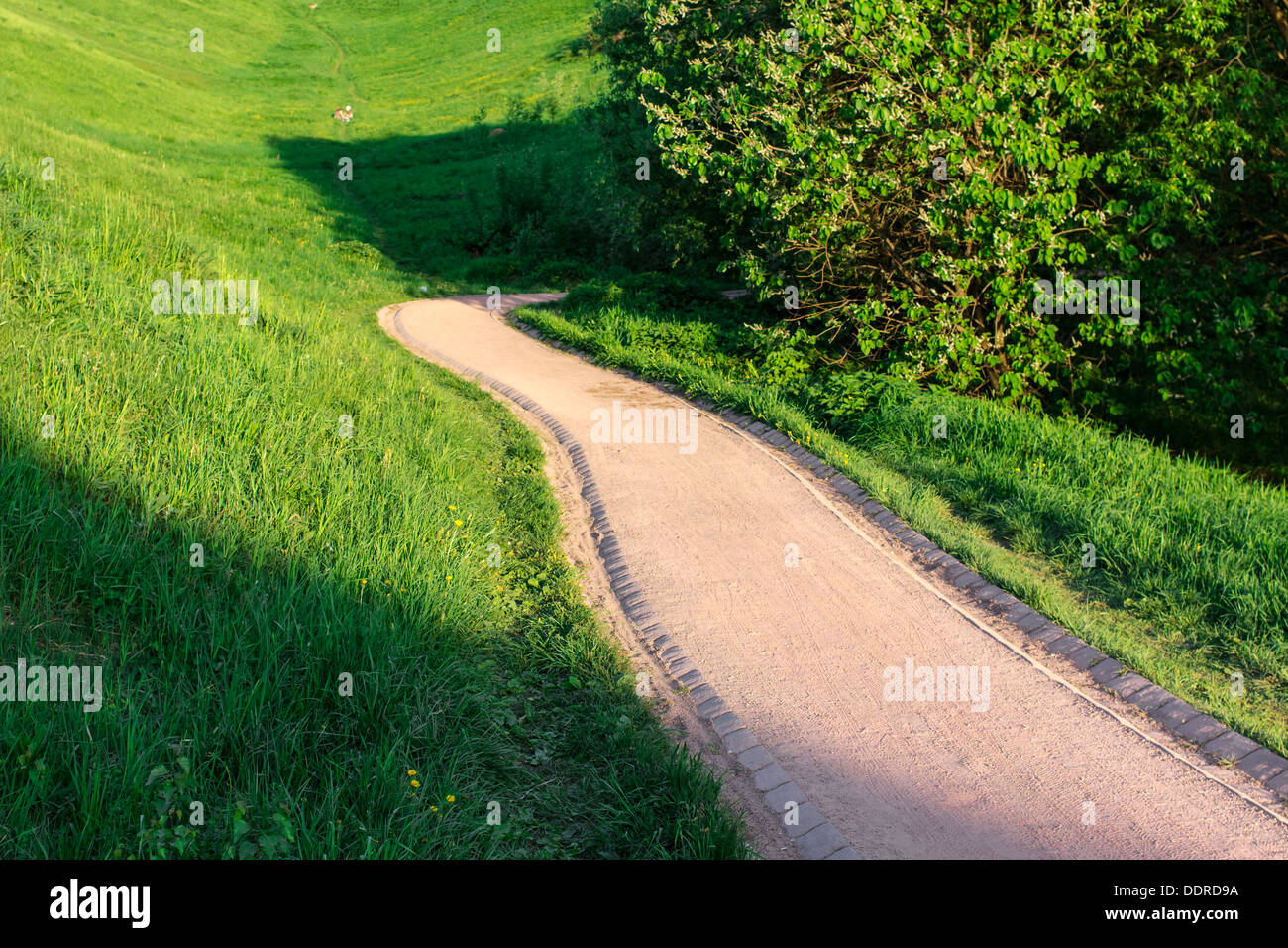 Red path in a green park on the hillside Stock Photo - Alamy
