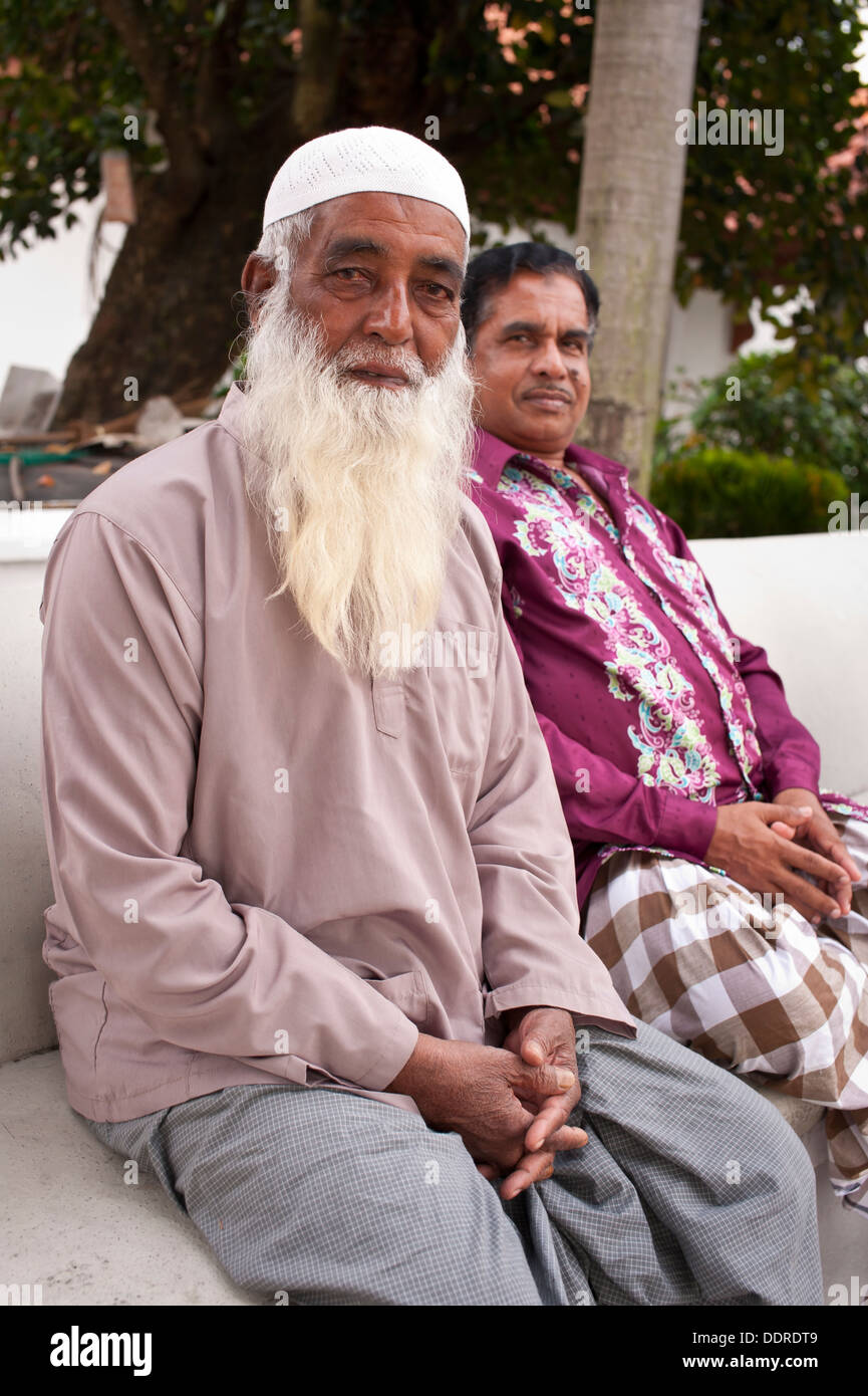 Two old friends sit together outside the mosque, Penang Stock Photo - Alamy