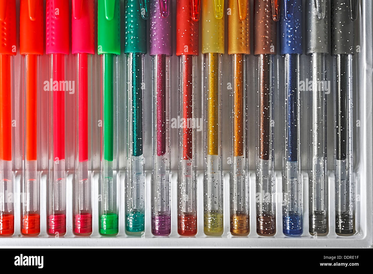 Set of multicolored pens placed horizontally on a stand Stock Photo - Alamy
