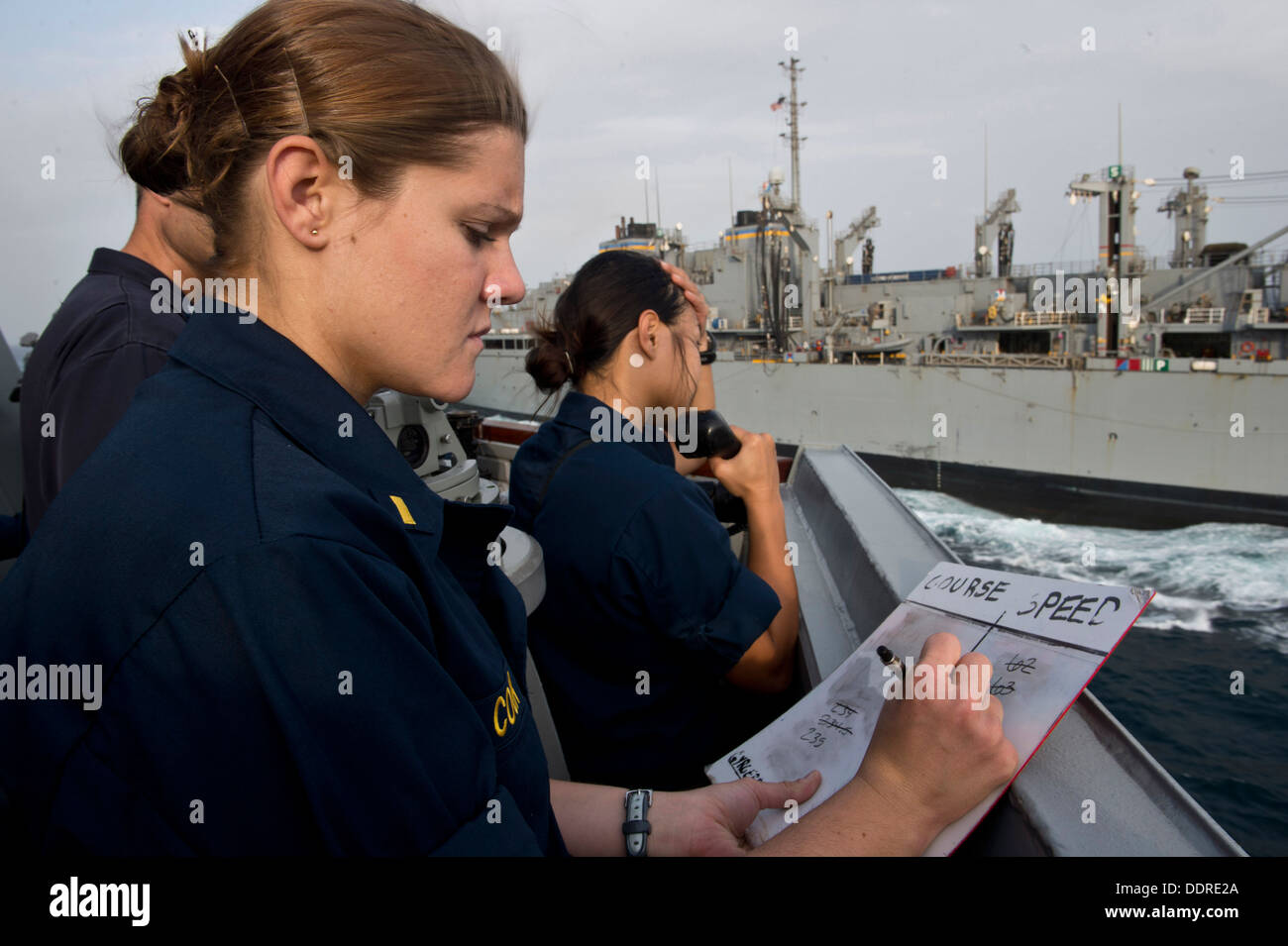 Ensign Alyssa Cook tracks the ship's course and speed during an ...