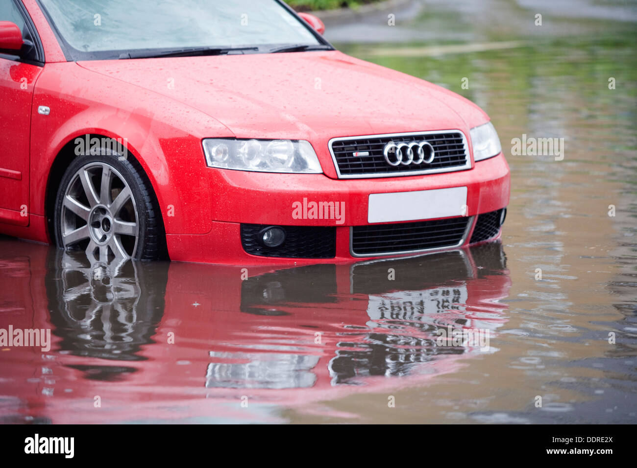 Red car sitting in a flooded car park, Scotland Stock Photo - Alamy