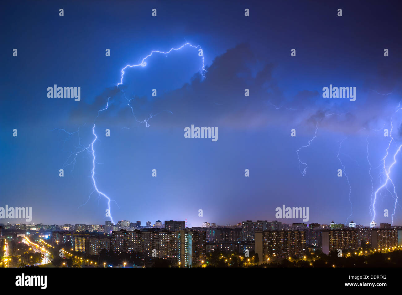 Lightning over the city at night with illuminated city Stock Photo - Alamy