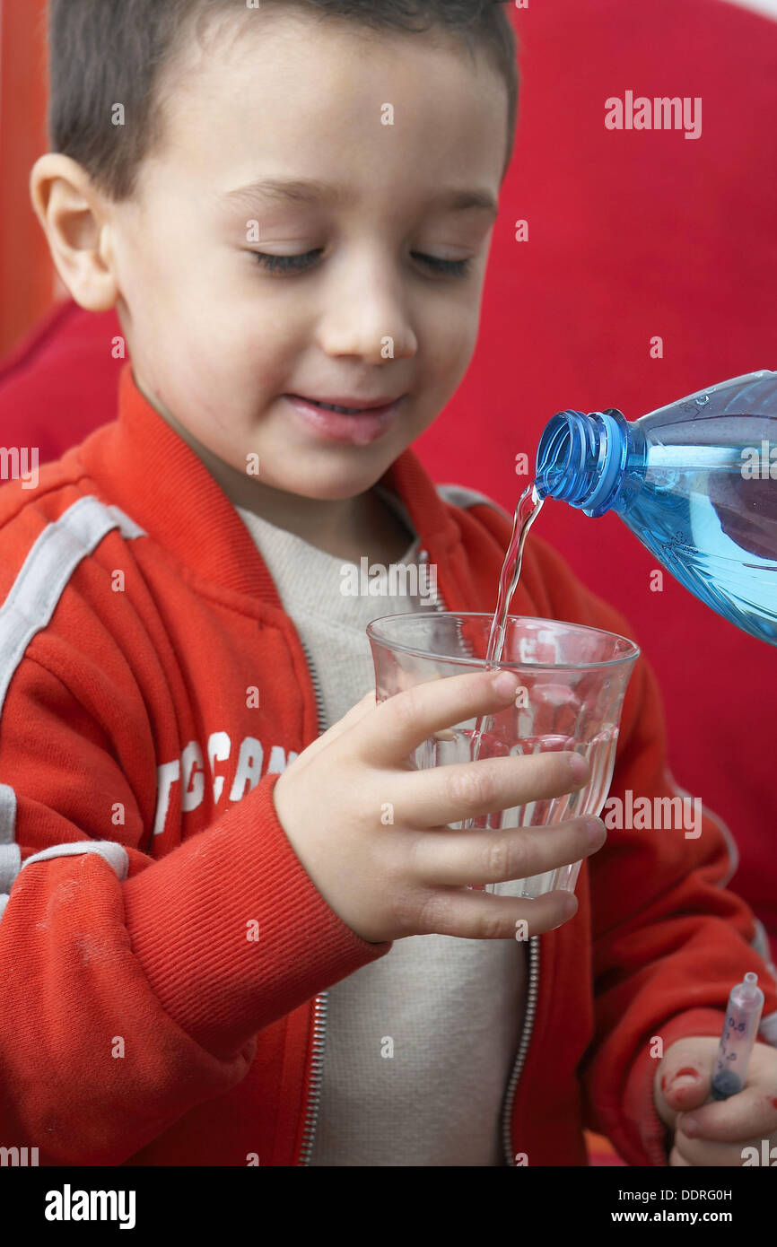 Boy pouring water glass hi-res stock photography and images - Alamy
