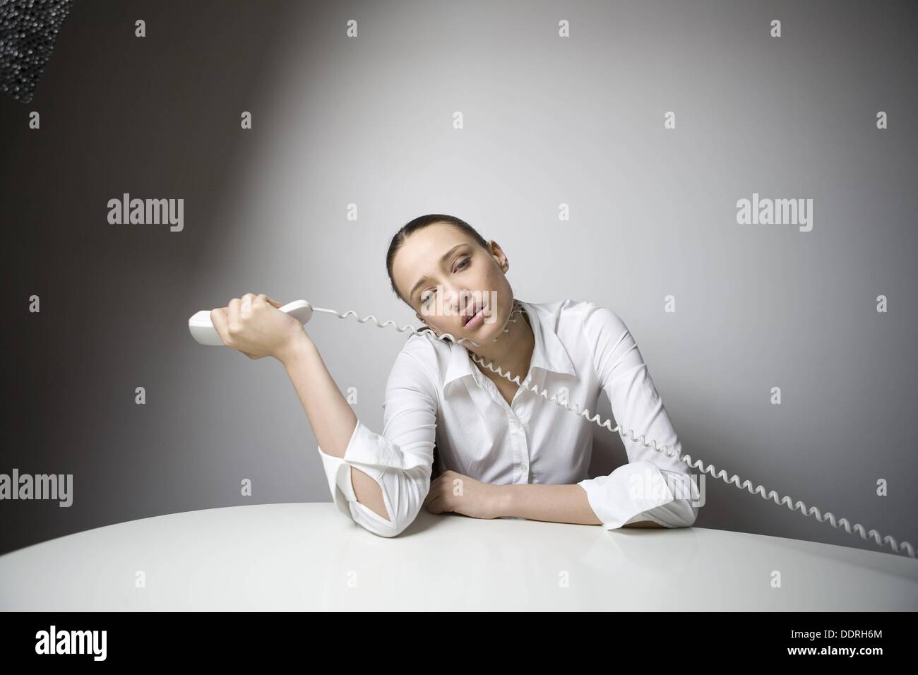 Bored Worker Office Woman playing with phone Stock Photo - Alamy