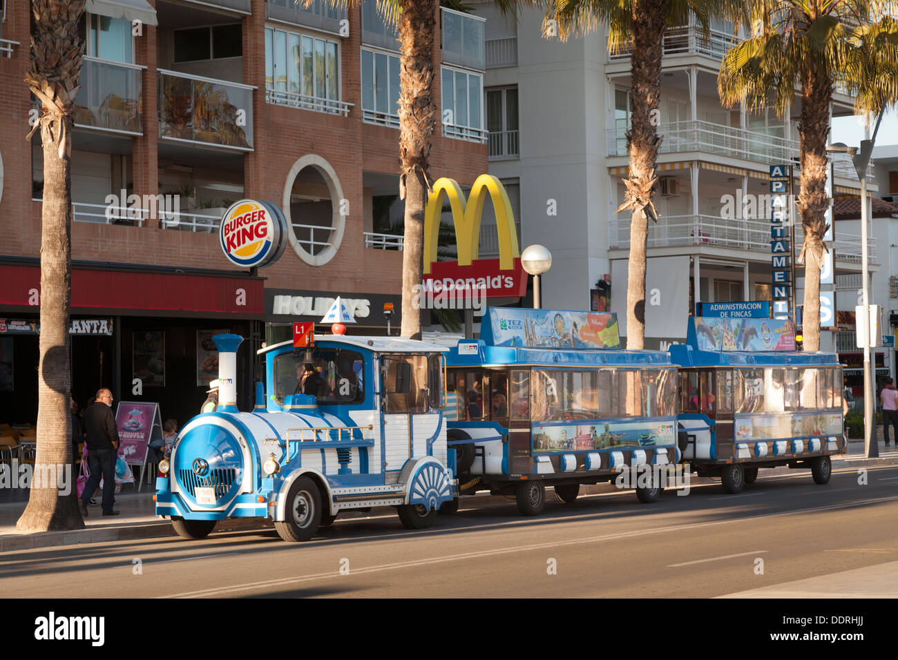 The mini tourist bus train infront of MsDonalds and Burger King at ...
