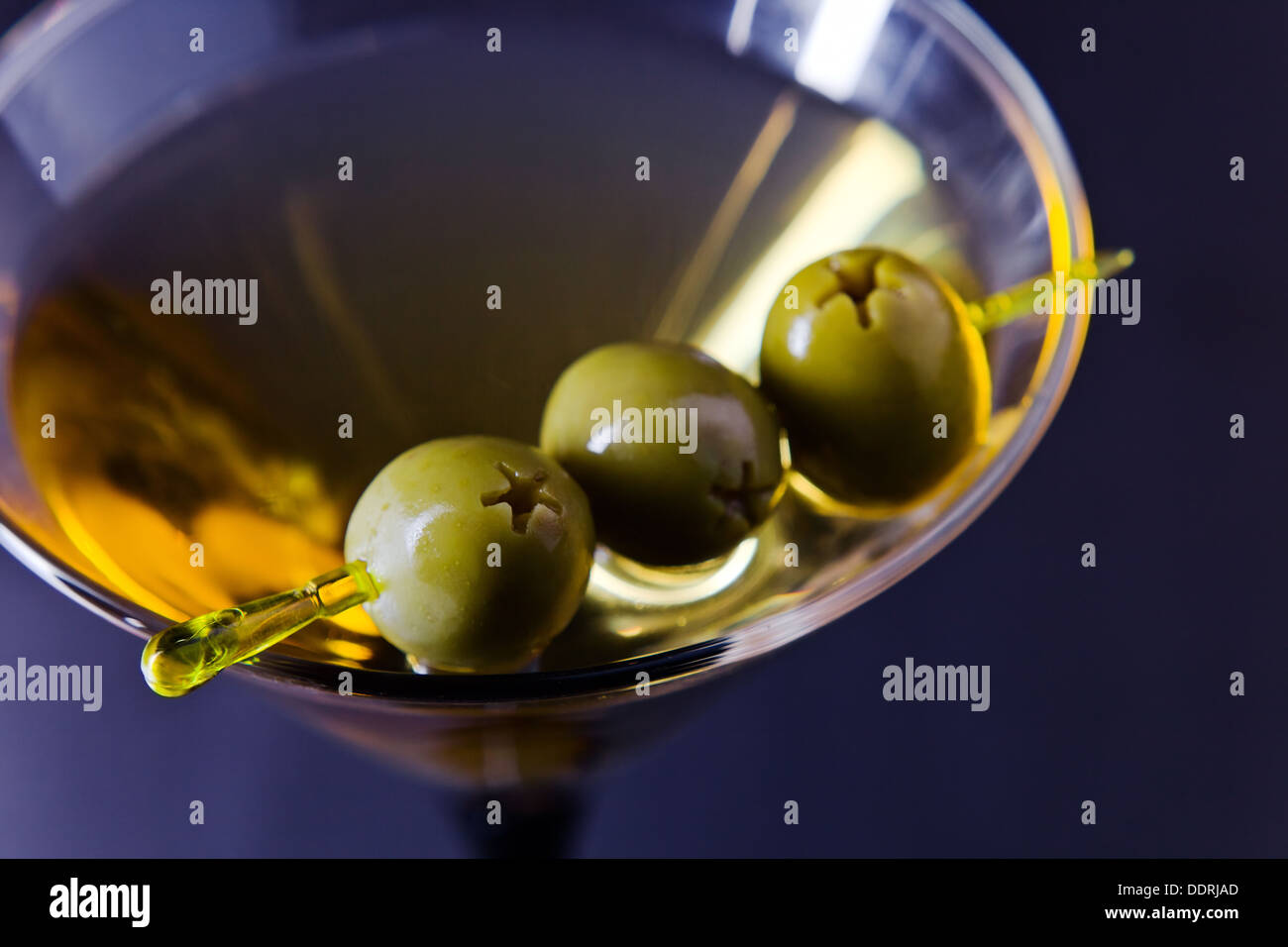 martini with green olives , focus on oliwes Stock Photo - Alamy