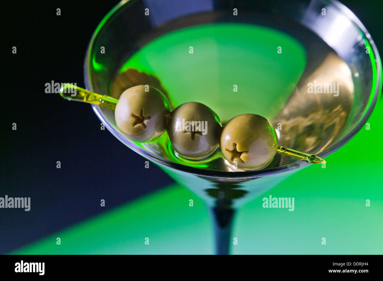 martini with green olives , focus on oliwes Stock Photo - Alamy