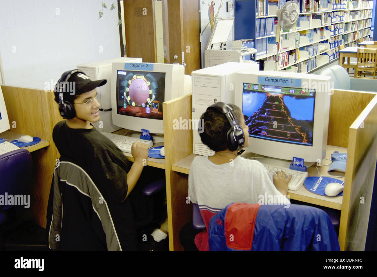 Black brothers work on computer in a library Stock Photo - Alamy