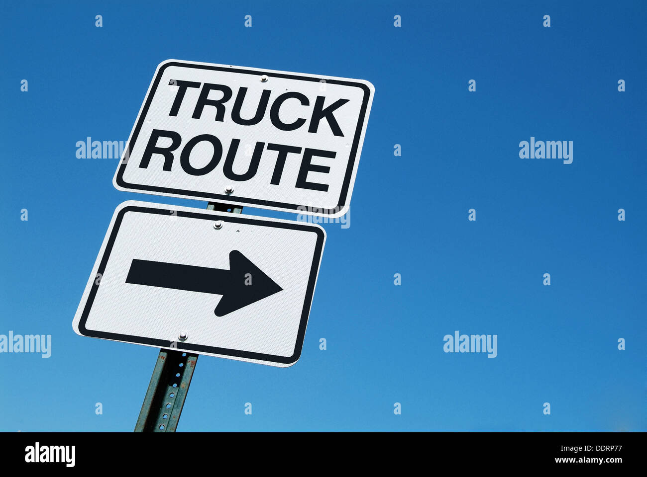Truck route sign with a turn direction arrow shows routes for large ...