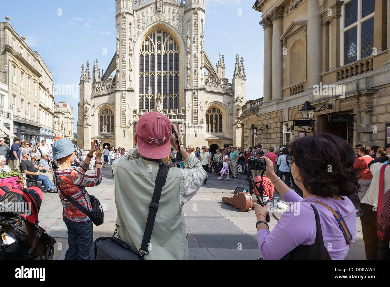 Tourists are shown photographing Bath Abbey and the pump rooms in Bath ...