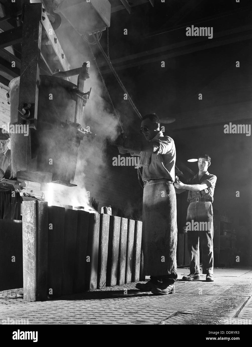 Worker pouring molten metal Black and White Stock Photos & Images - Alamy