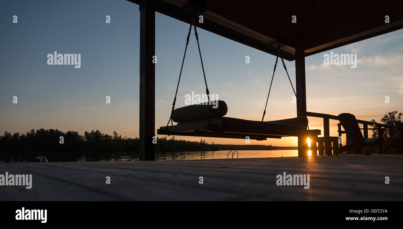 Swing chair on dock lake hi-res stock photography and images - Alamy