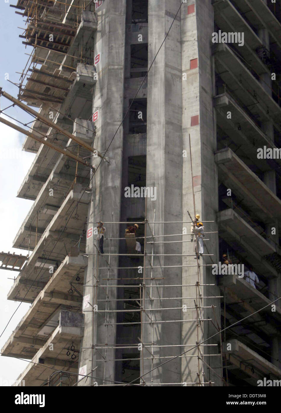 Laborers busy in constructions work on a building without any safety ...