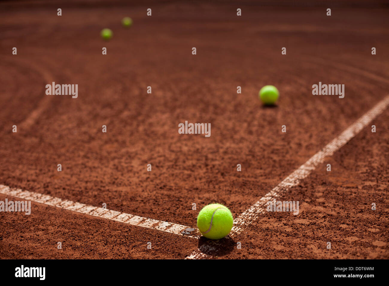 Tennis balls and rocket on court field in sunny day Stock Photo - Alamy