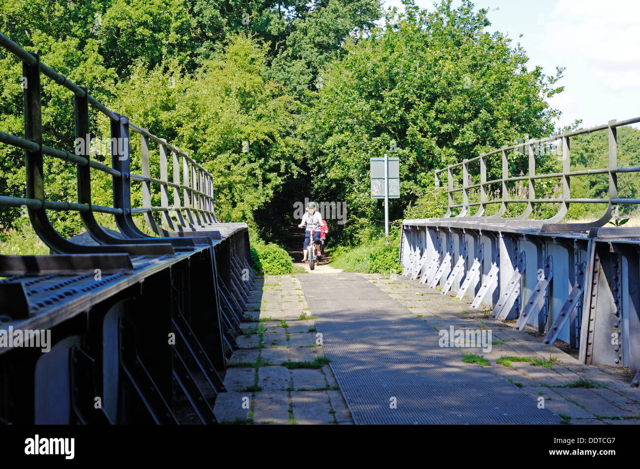 Cyclists crossing an old railway bridge on the Marriott's Way long ...