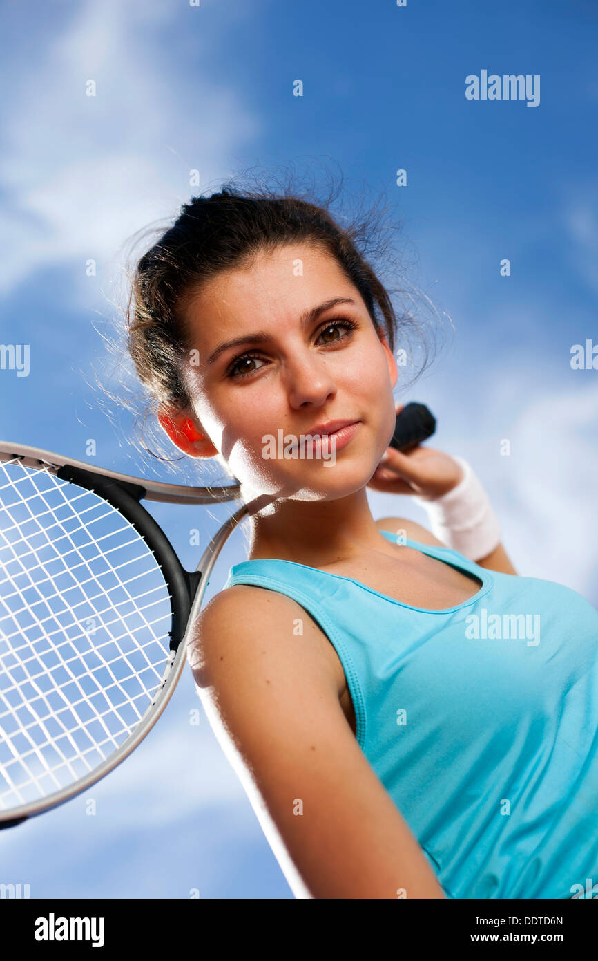 Pretty girl playing in tennis on court Stock Photo - Alamy