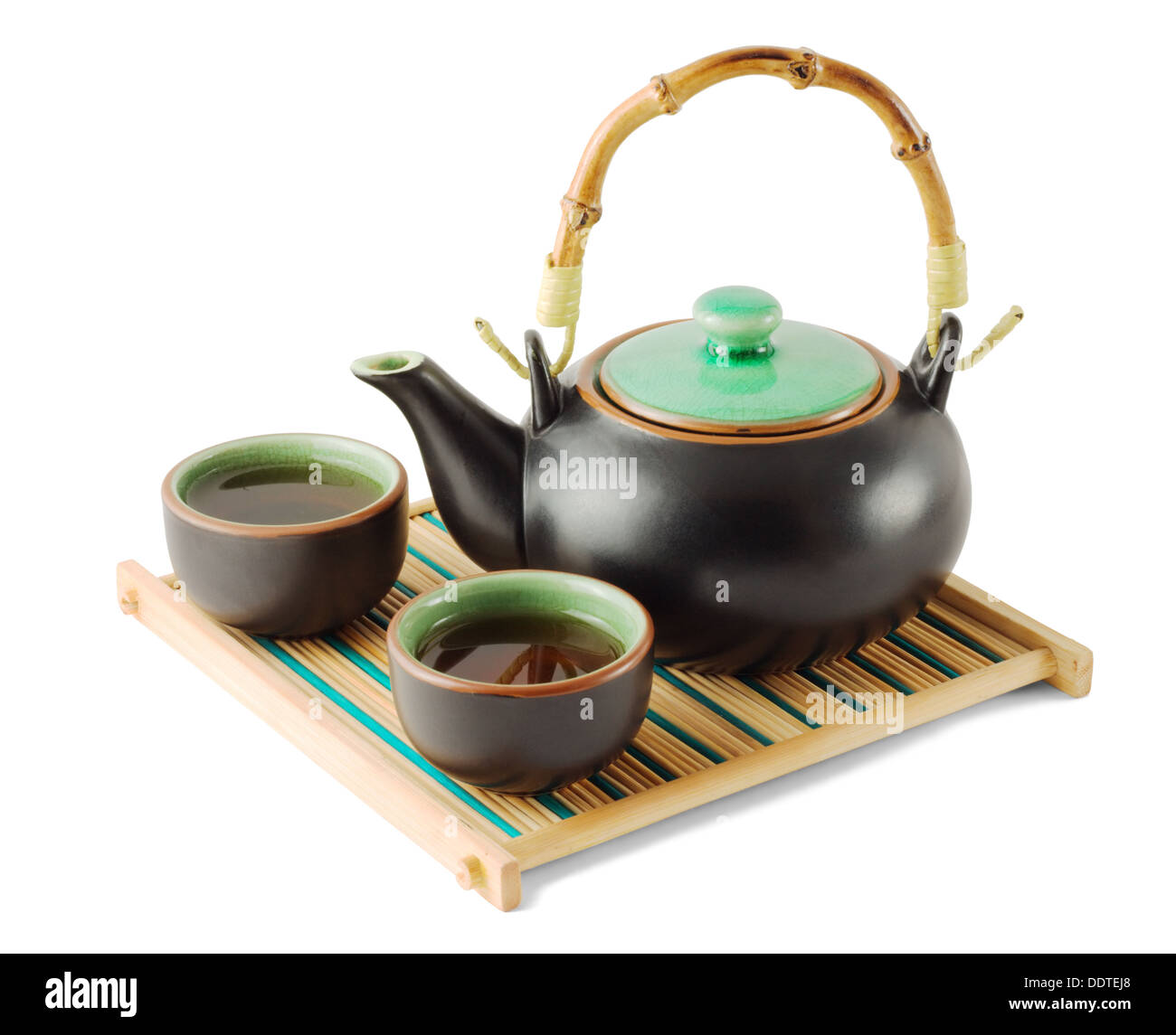 Brown teapot and teacups on the wooden trivet isolated on white ...