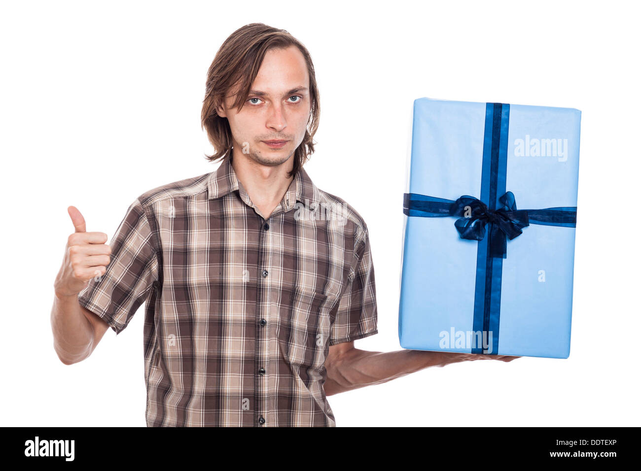 Serious man holding big blue gift box showing thumb up, isolated on ...