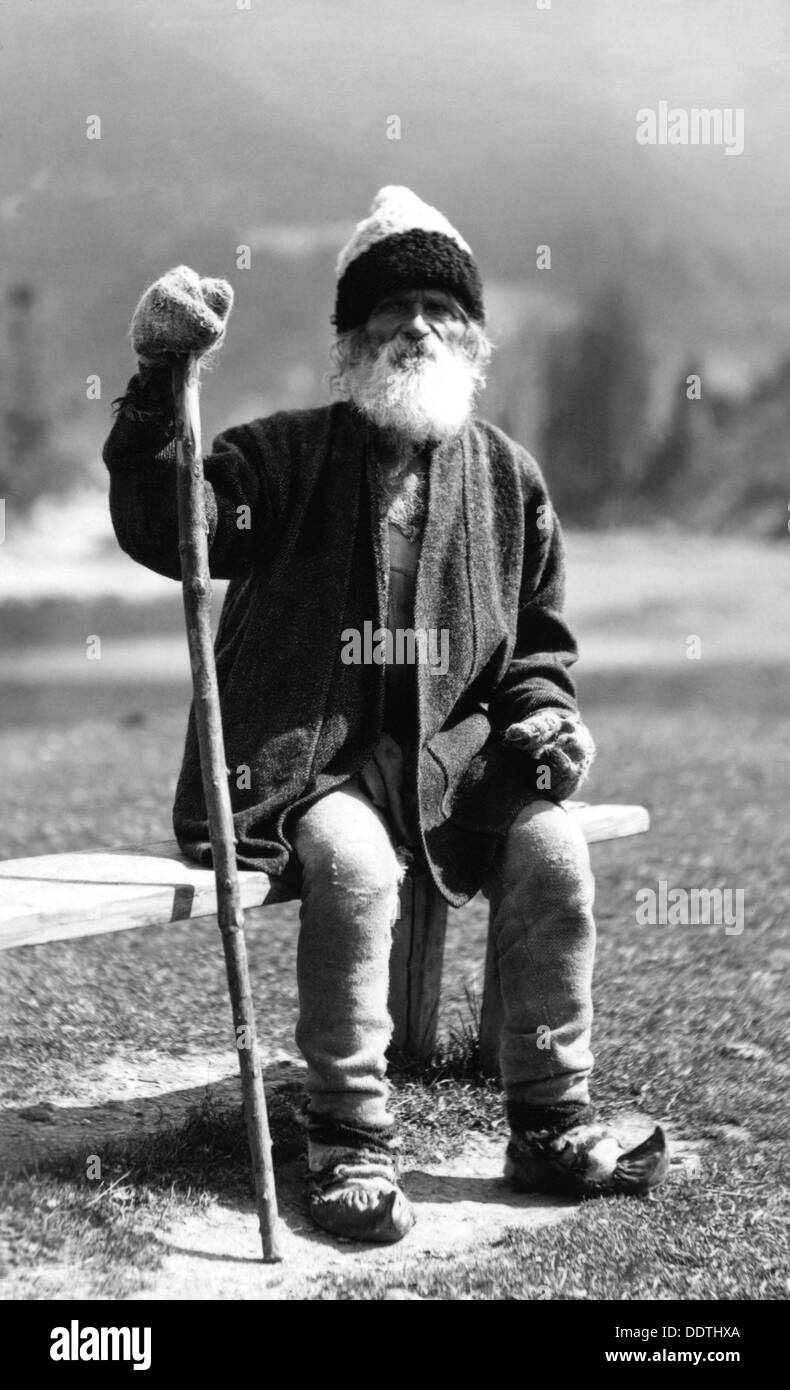 Old man sitting on a bench, Bistrita Valley, Moldavia, north-east ...
