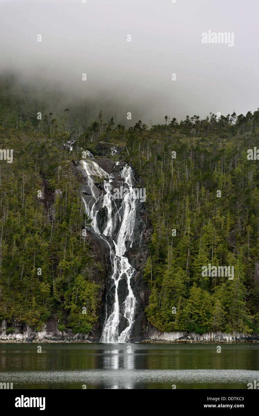 Waterfall emerging from the mist, Sarah Island, mid-coast British ...