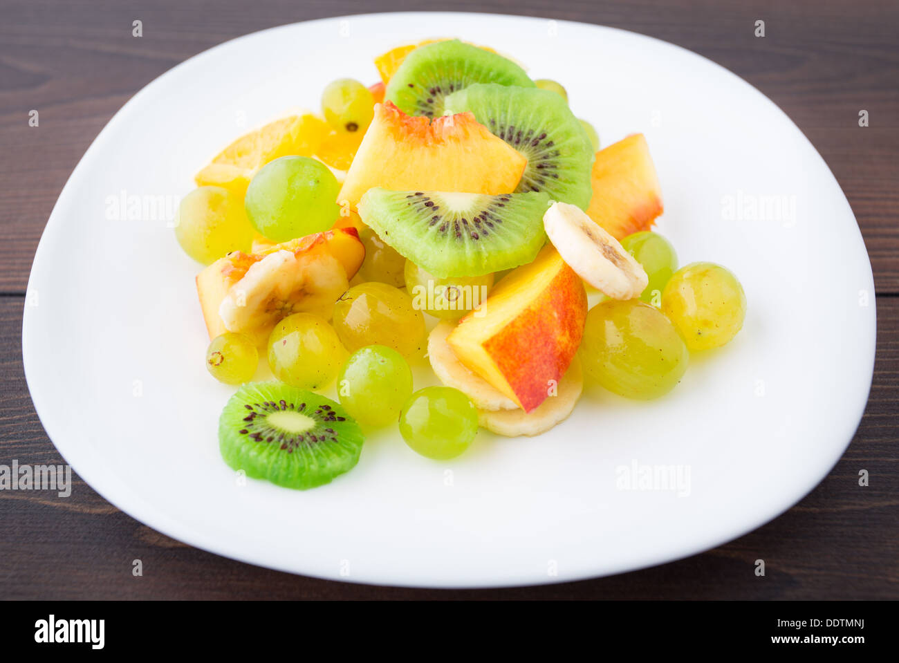 Assortment of sliced fruits on plate Stock Photo - Alamy
