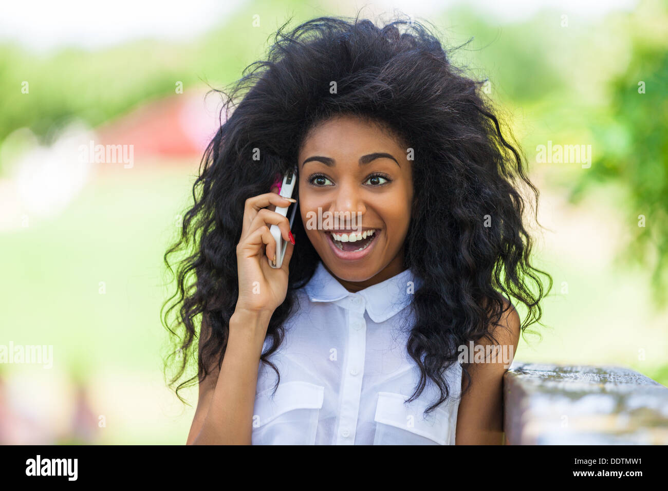Outdoor Portrait Of A Teenage Black Girl Using A Mobile Phone African
