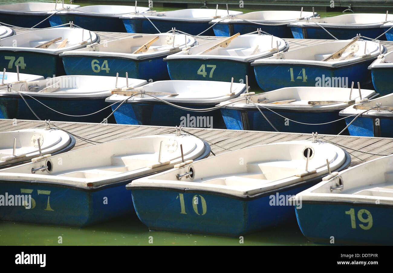 Many blue boats on the lake waiting the rowers Stock Photo - Alamy