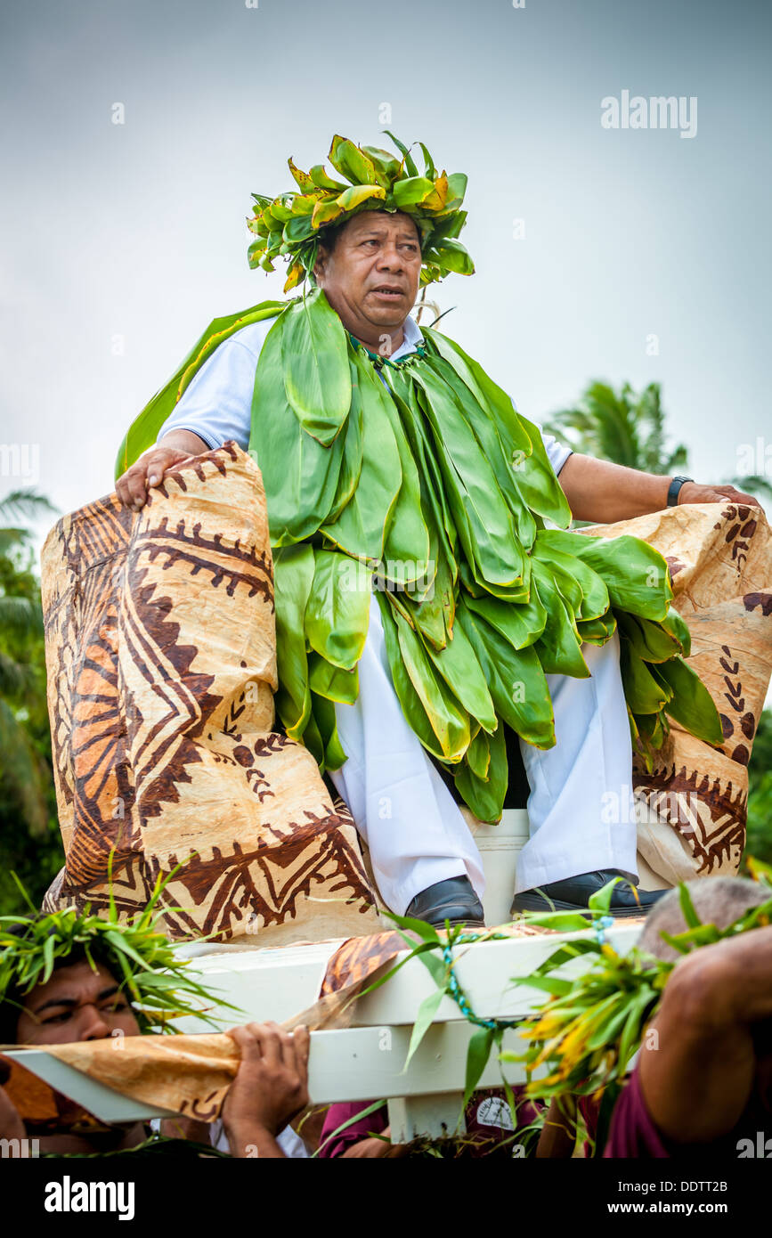 COOK ISLANDS - Makirau Haurua in traditional costume being carried on ...
