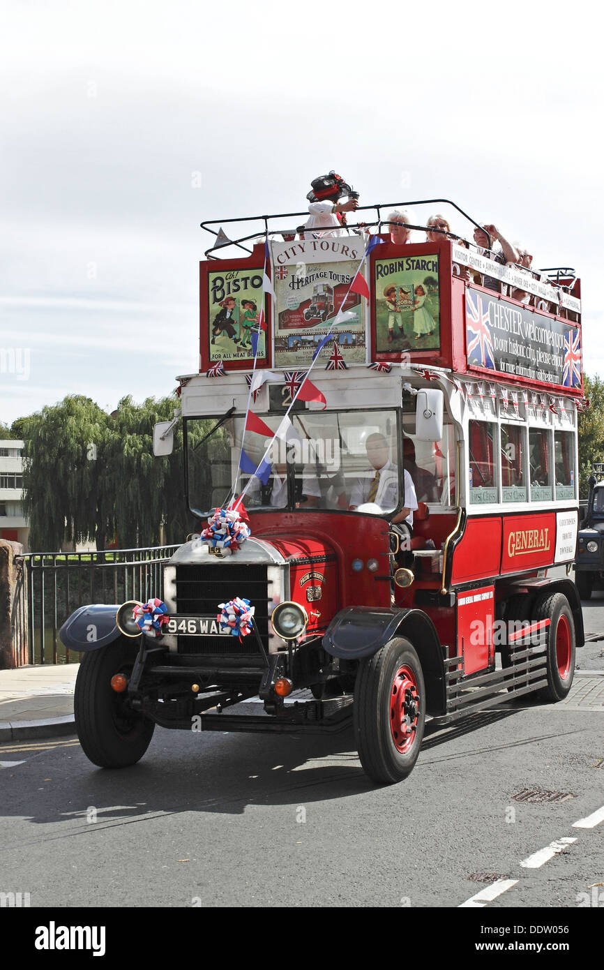 Sightseers on a City tour of Chester, England, in a vintage open topped ...
