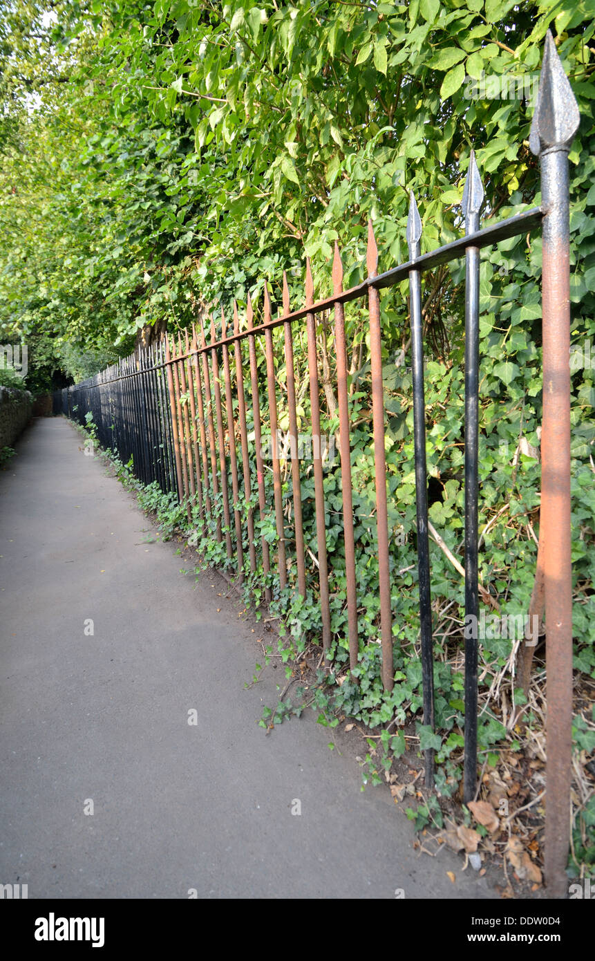 Path with rusty fence/railing, England UK Stock Photo - Alamy